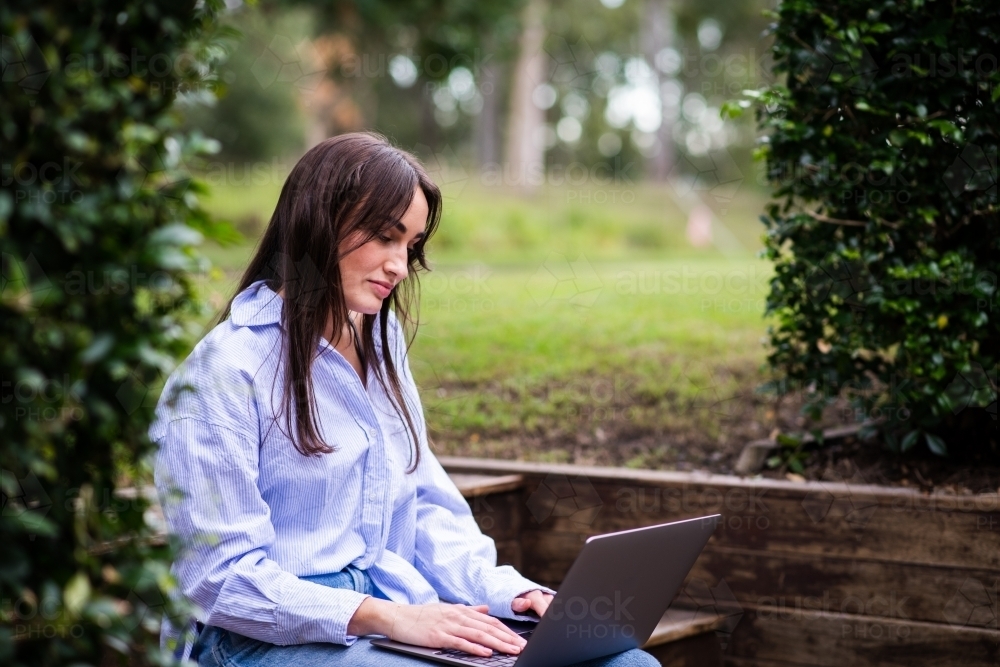 Image of student using computer on campus - Austockphoto