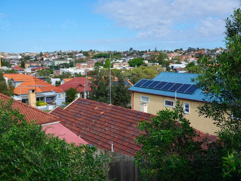Image of suburban landscape with multiple houses with red and blue ...