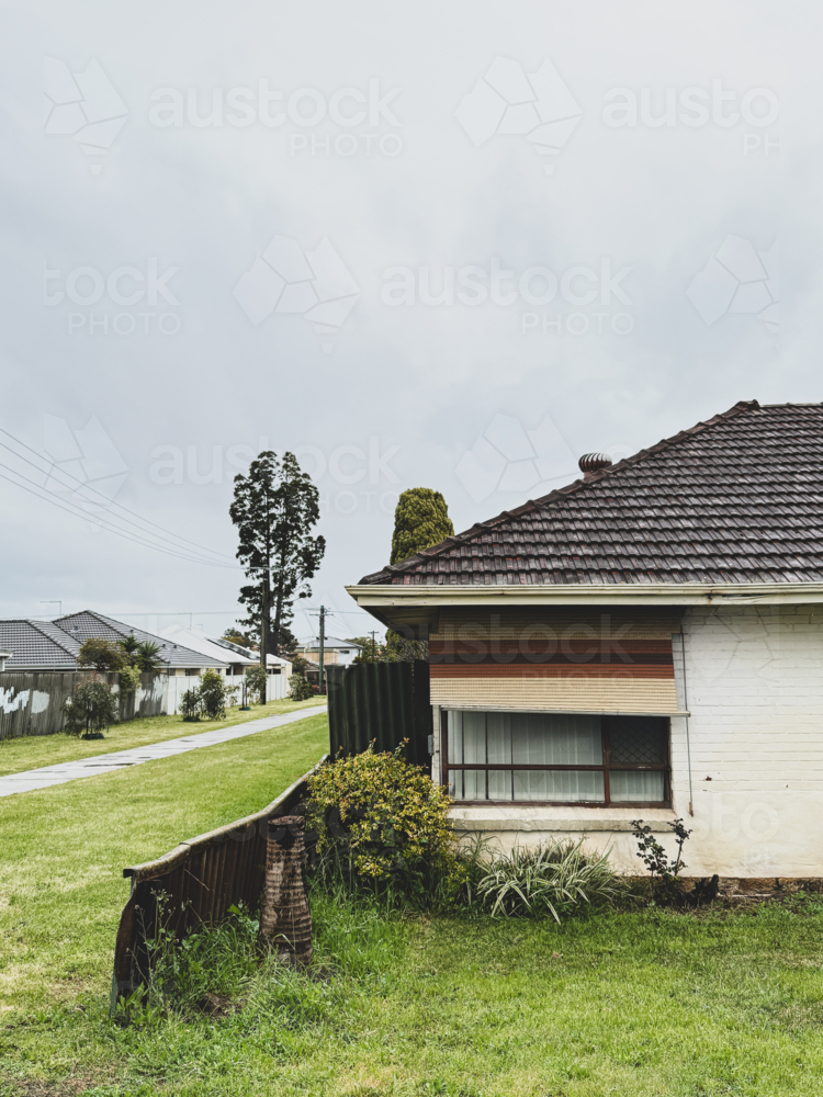 Image of Suburban scene of old weatherboard house with window and aging ...