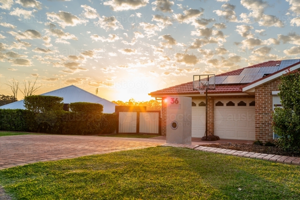 Image of Suburban sunrise with dotted clouds over homes and mailbox ...