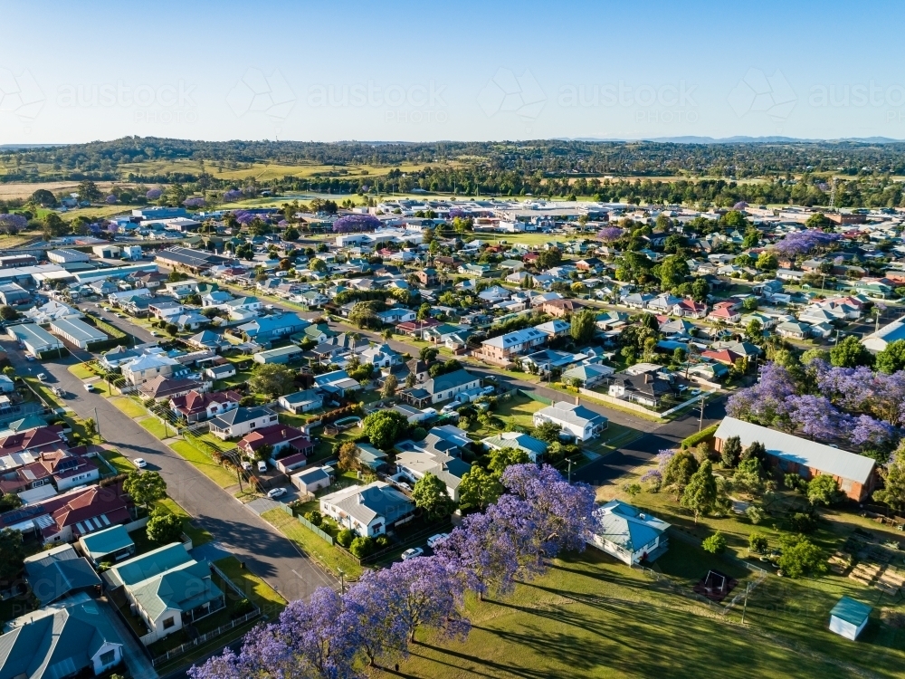 Image of Suburbs with small homes beside park in town with street lined ...