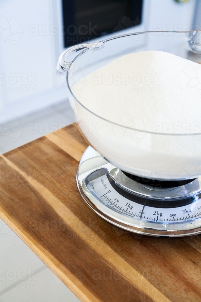 Image of Sugar being measured out for making jam on kitchen scales ...