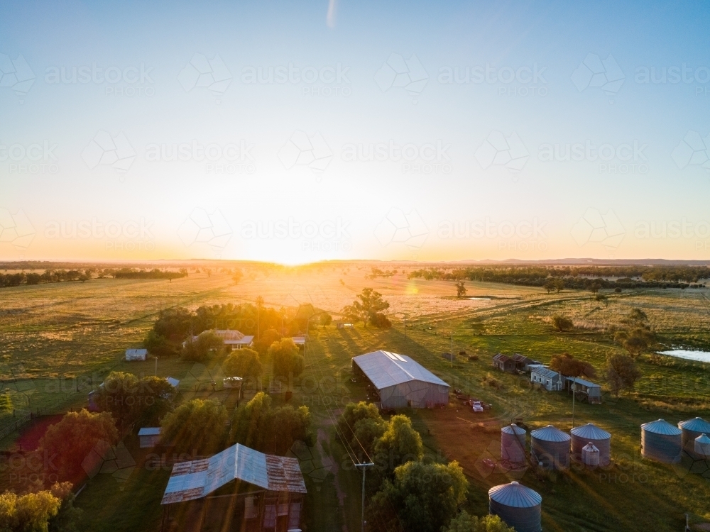 Image of Sun on horizon with clear open sky and rural farm scene ...