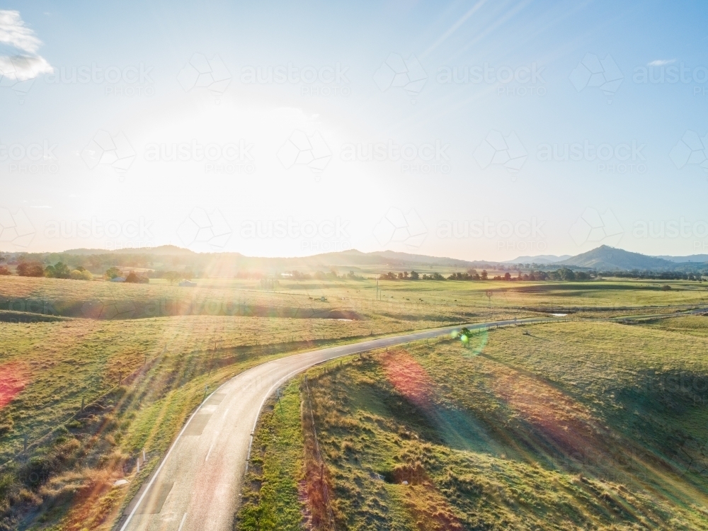 Image of Sun rays over road in farmland in Melville Hunter Valley ...