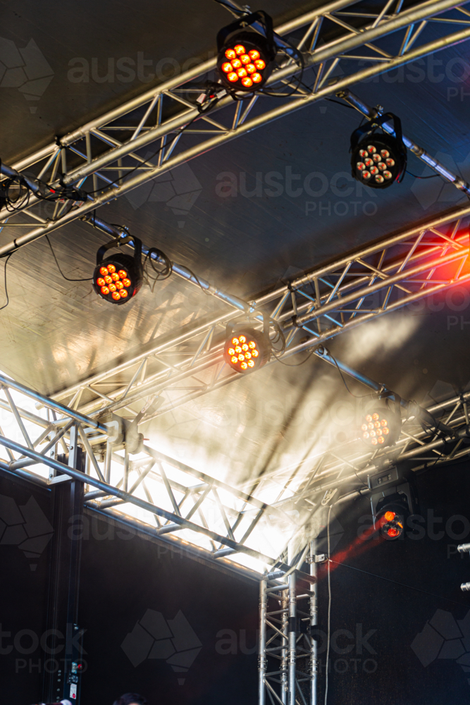 Image of Sun rays through mist with lights above stage at outdoor ...