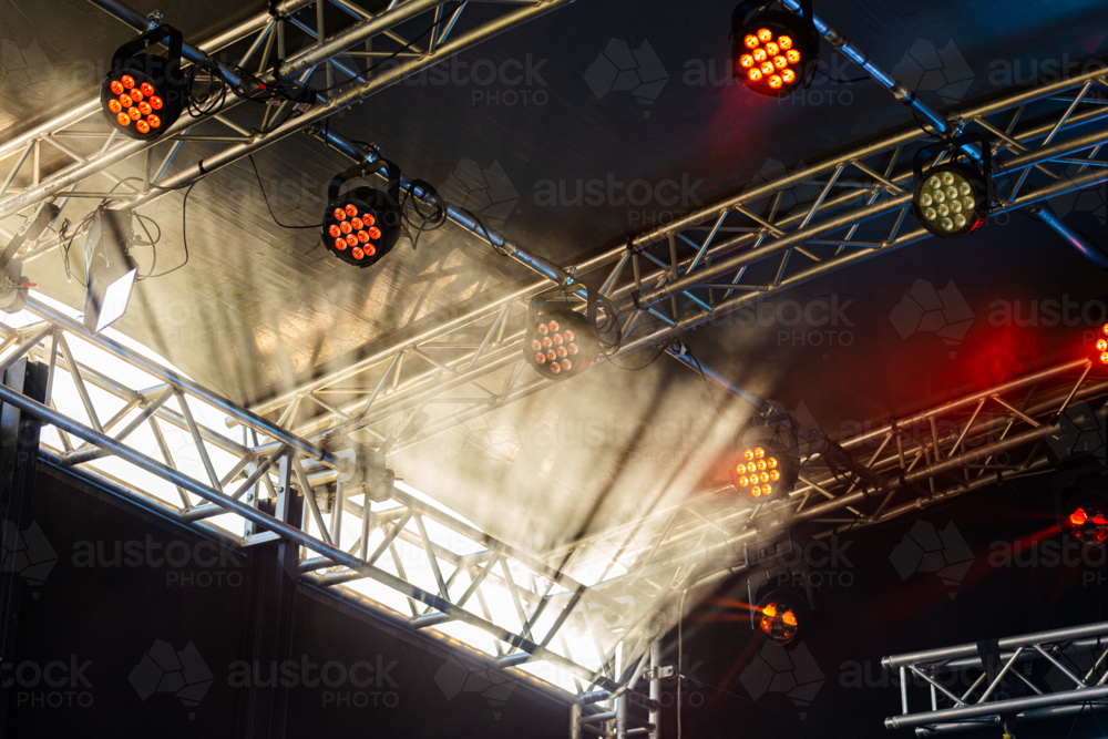 Image of Sun rays through mist with lights above stage at outdoor ...