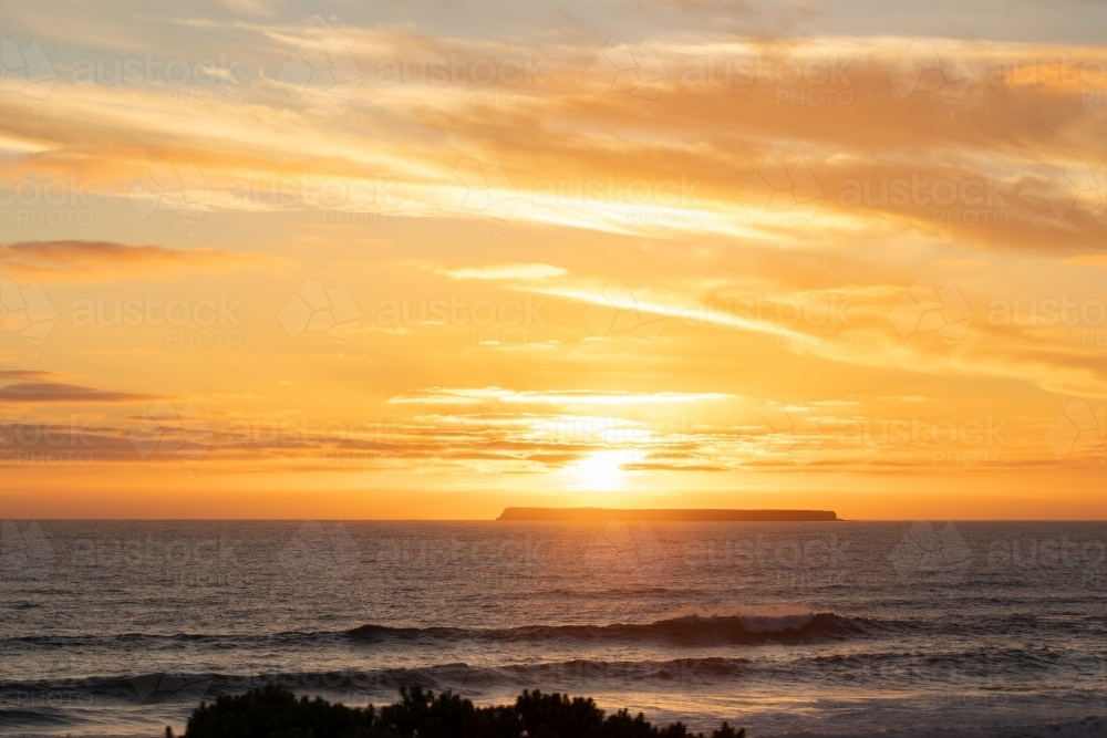 Image of Sun setting behind Lady Julia Percy Island viewed across the ...