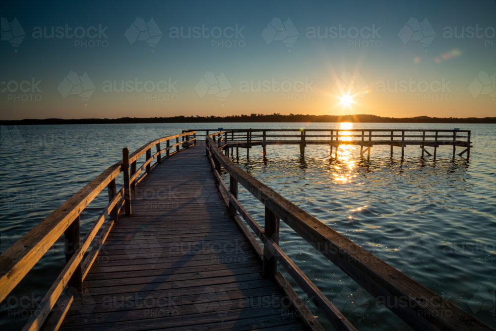 Image of Sun setting beyond a wooden boardwalk at Lake Clifton ...