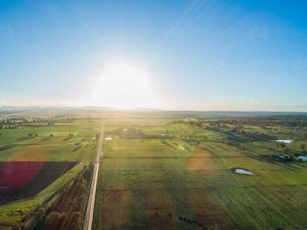 Image of Sun setting in blue sky over rural Australian agricultural ...