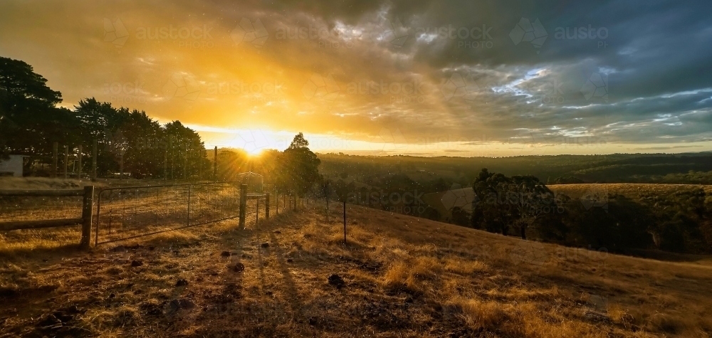 Image of Sun Setting Over Farmland - Austockphoto