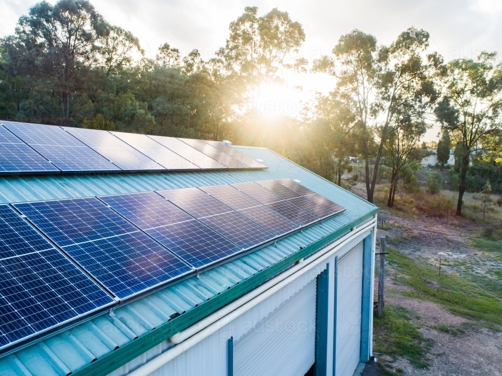 Image of Sunlight over solar panels installed on roof of country home ...