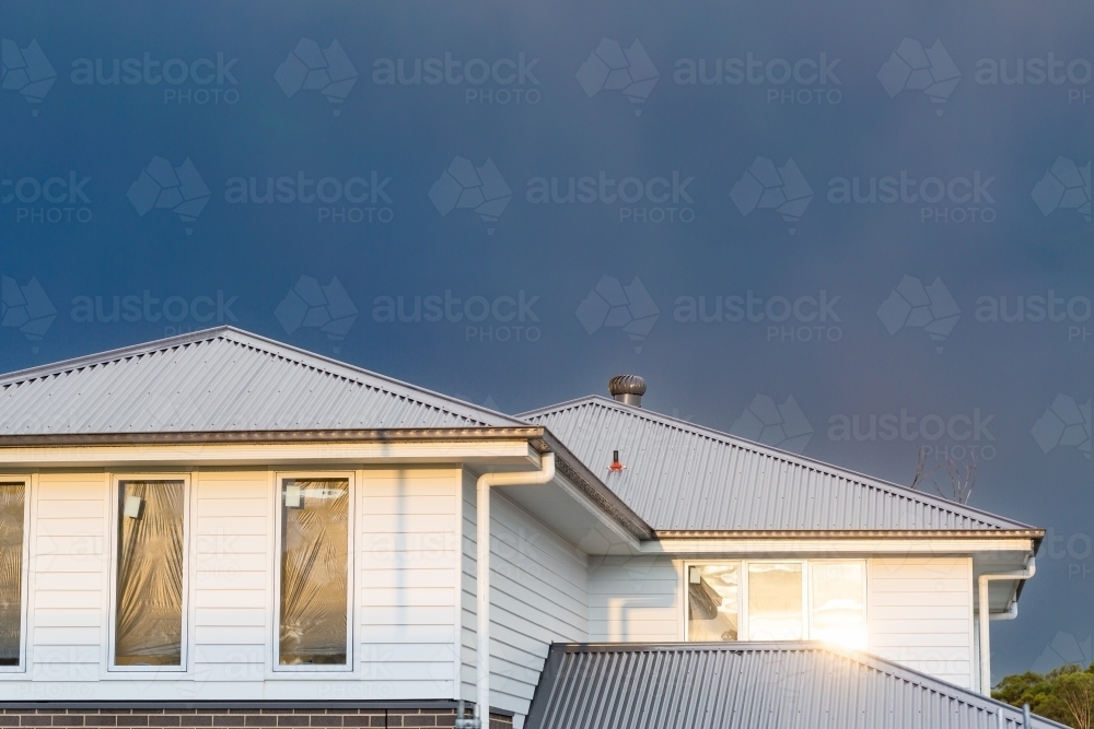 Image of Sunlight reflecting off window of new house build under ...