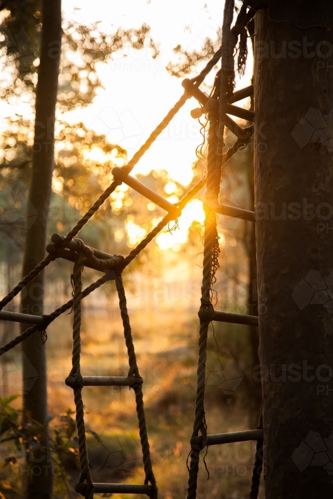Image of Sunlight shining through rope climbing ladder - Austockphoto