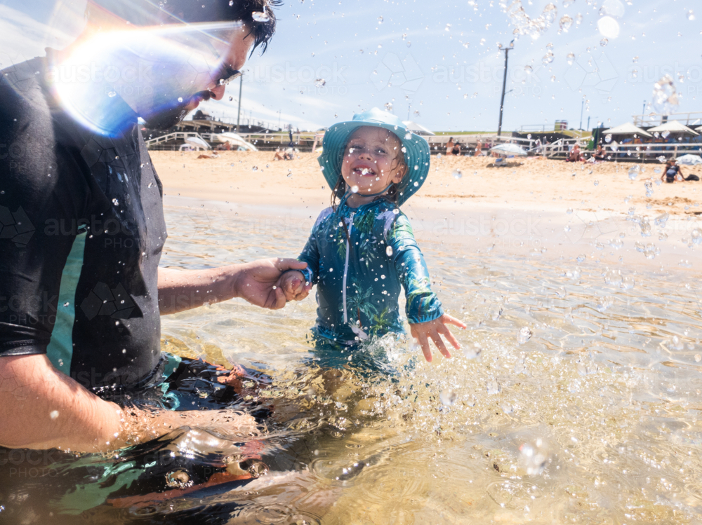 Image of sunlight sparkling of waterdrops splashed by toddler playing ...