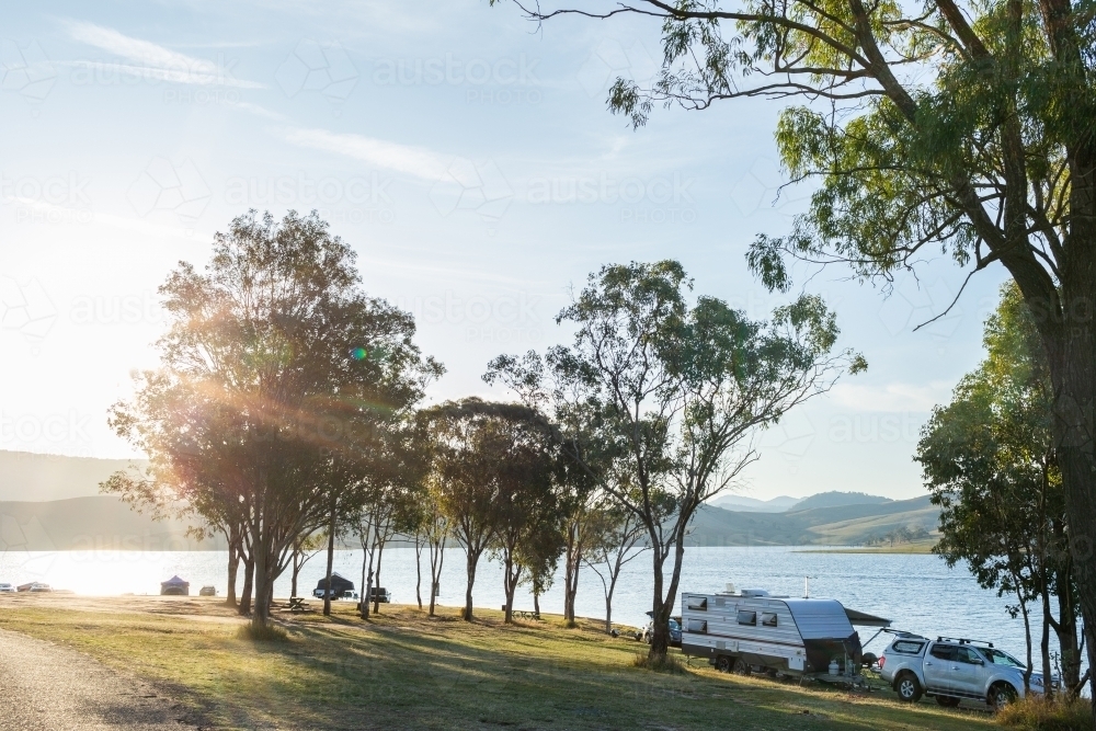 Image of Sunlight through gum trees of lakeside campground in Hunter ...