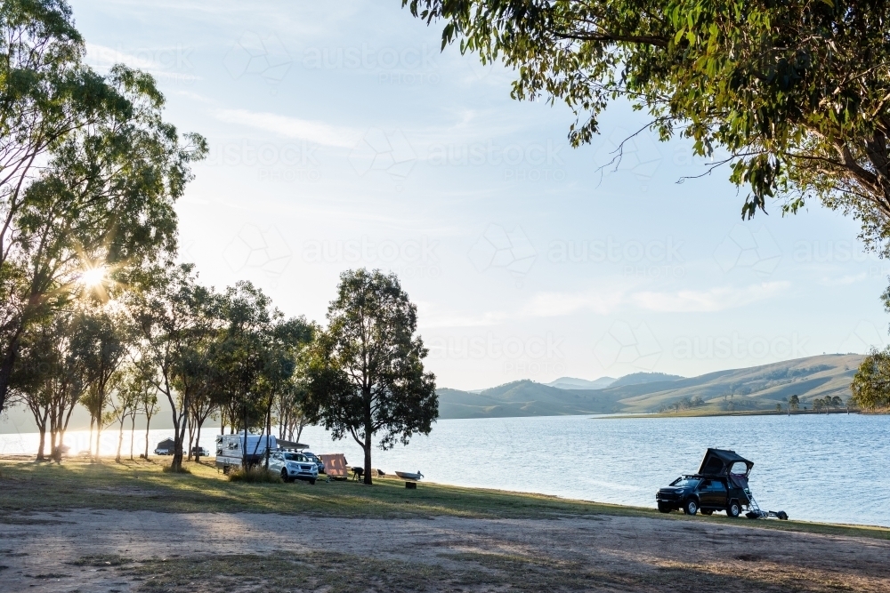 Image of Sunlight through gum trees of lakeside campground in Hunter ...