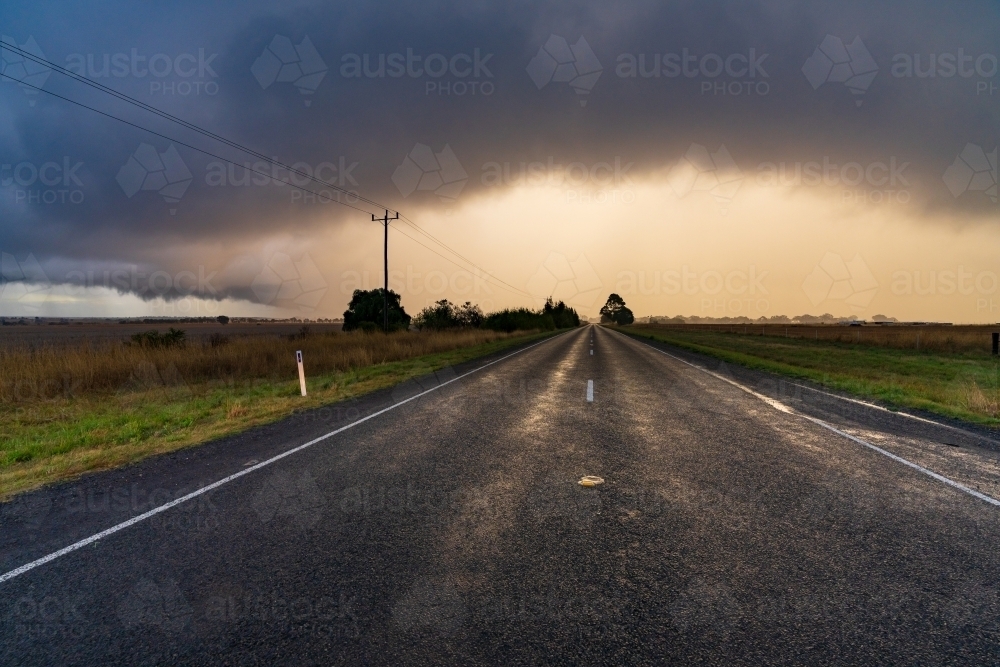 Image of Sunset behind rain falling from a dramatic stormfront over ...