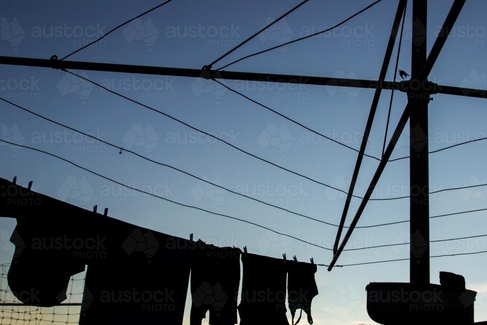 Image of Swimmers and towels hanging on the washing line at dusk ...