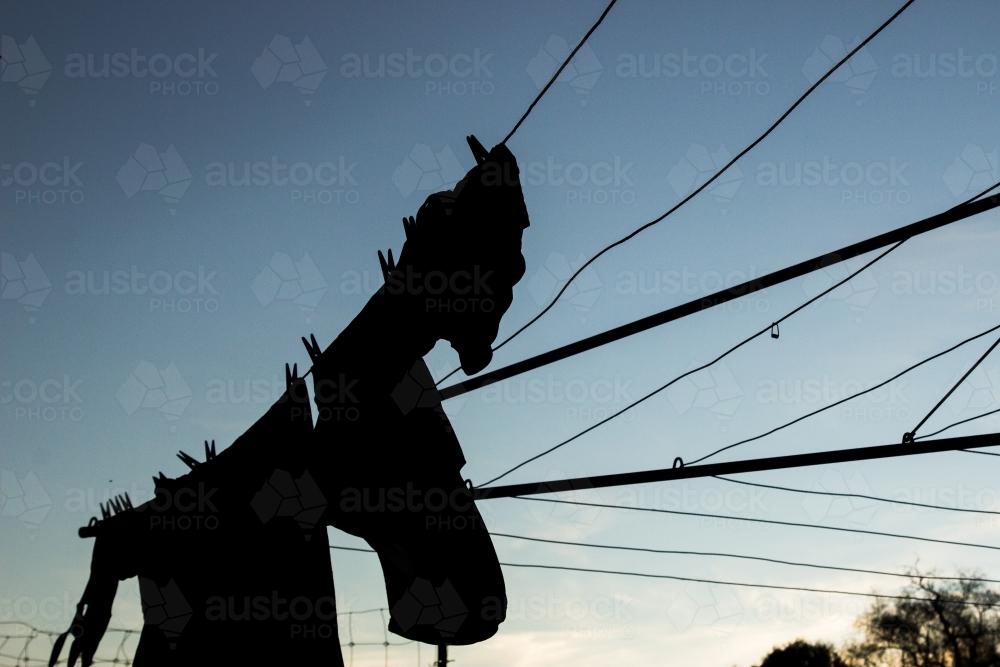 Image of Swimmers and towels hanging on the washing line at dusk ...