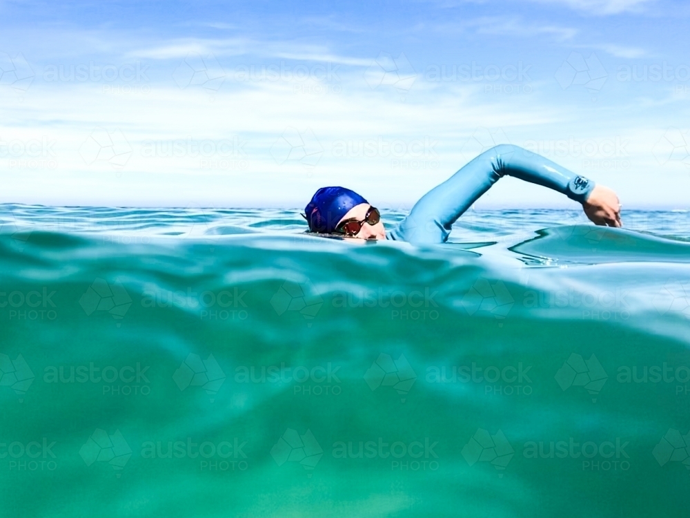 Image of Swimmers upper body seen from water level doing freestyle ...