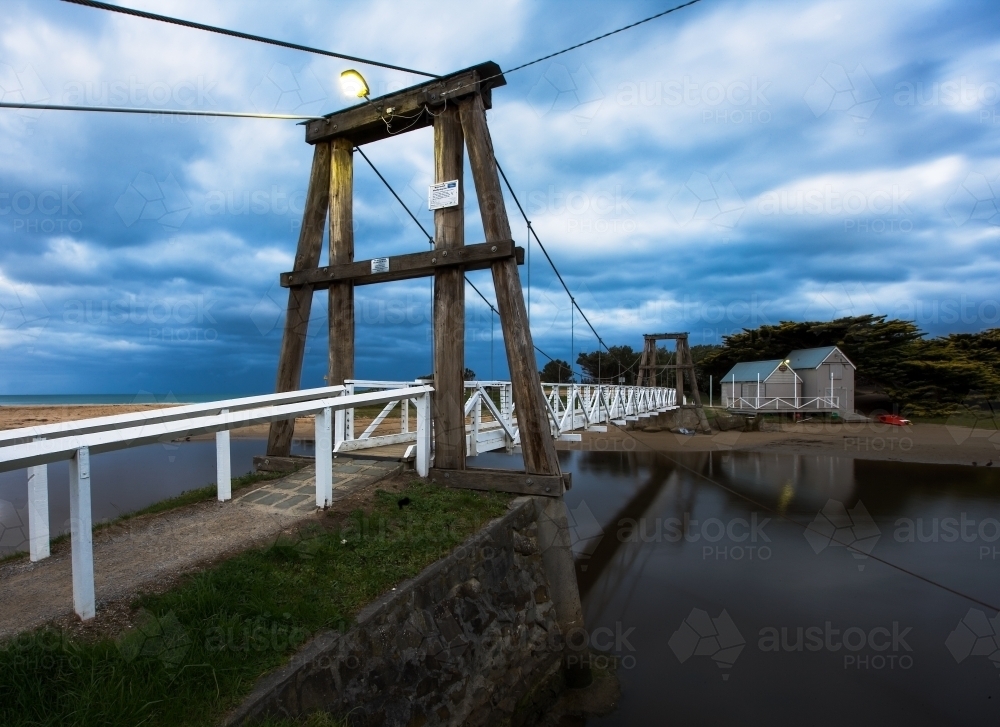 Image of Swing bridge over river and sheds at dusk - Austockphoto