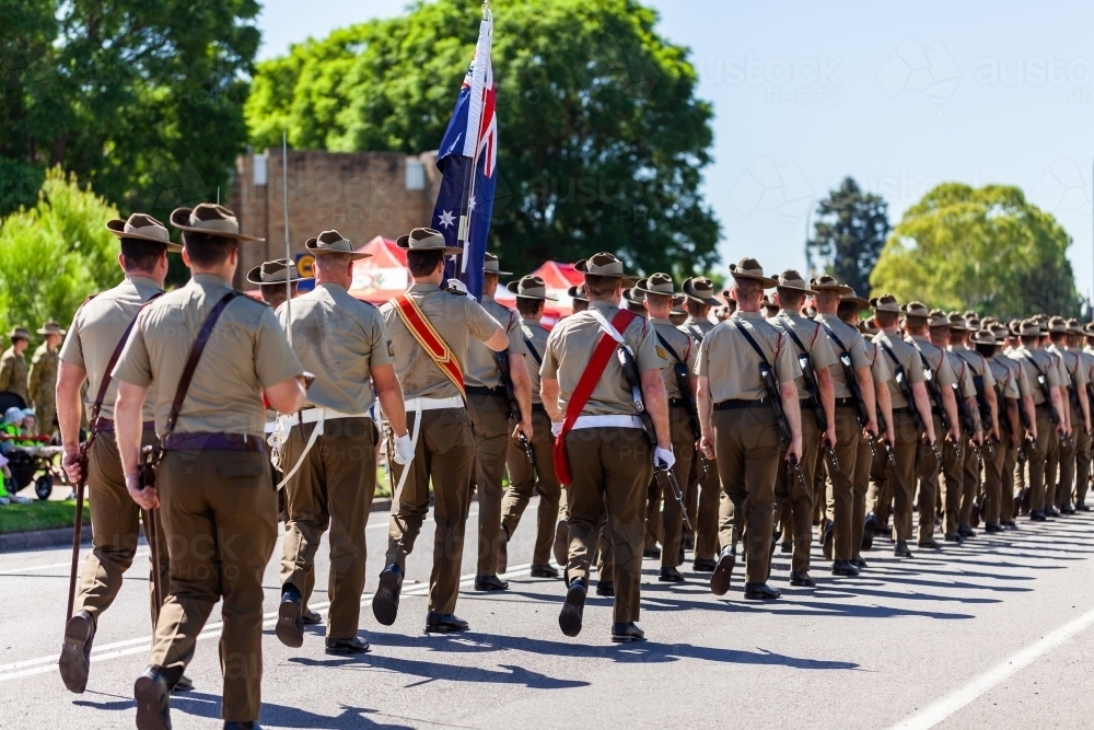 Image of Swords drawn, flag flying and bayonets fixed as soldiers march ...