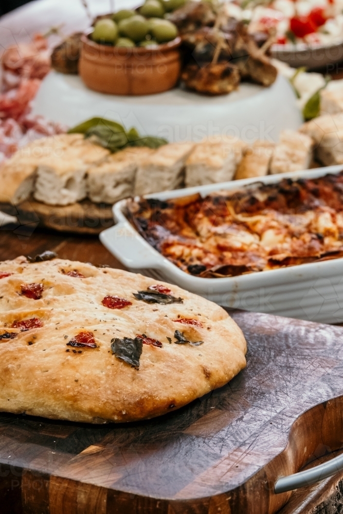 Image of Table with various foods at a gathering - Austockphoto
