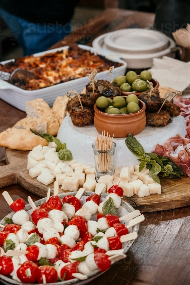 Image of Table with various foods at a gathering - Austockphoto