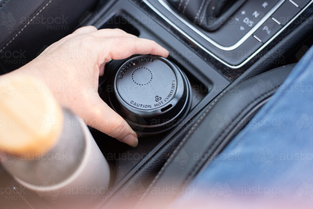 Image of takeaway coffee in car - Austockphoto