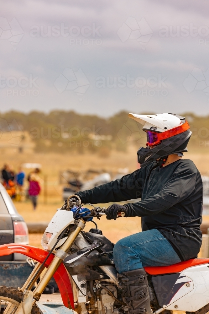 Image of Teen boy riding his motorbike at motocross track meet ...
