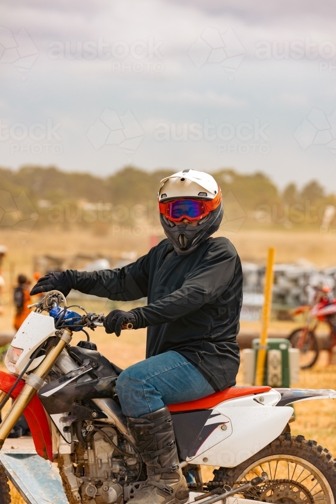 Image of Teen boy riding his motorbike at motocross track meet ...