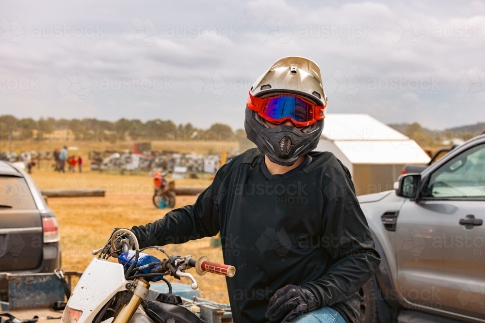 Image of Teen boy riding motorbike at motocross track meet - Austockphoto
