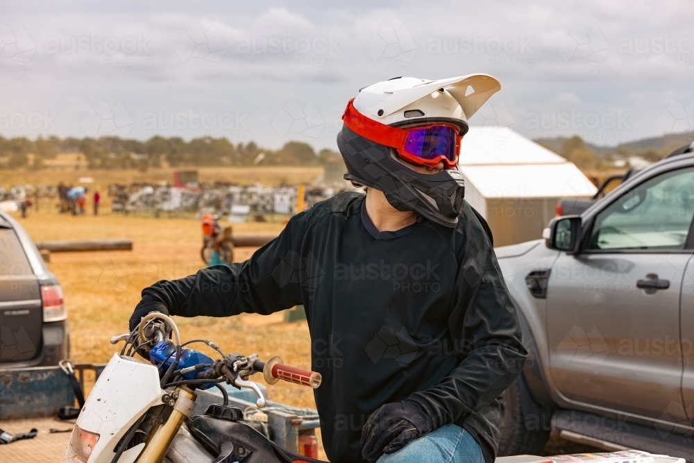 Image of Teen boy riding motorbike at motocross track meet - Austockphoto