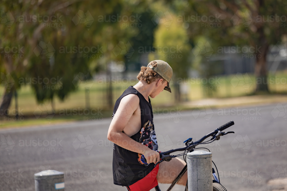 Image of Teen boy riding mountain bike at skate park - Austockphoto