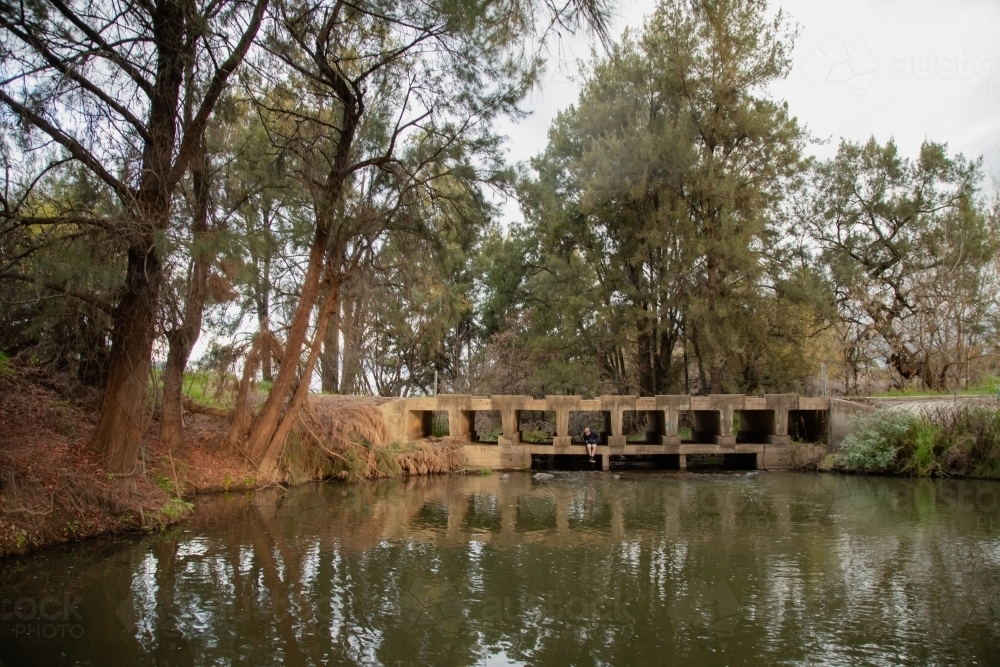 Image of Teen boy sitting under low bridge over the Cudgegong River in ...