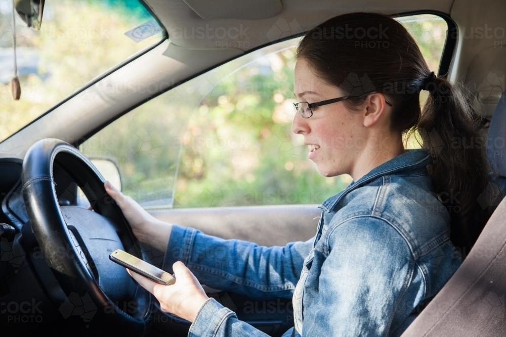 Image of Teen driver using phone in car - texting and driving ...
