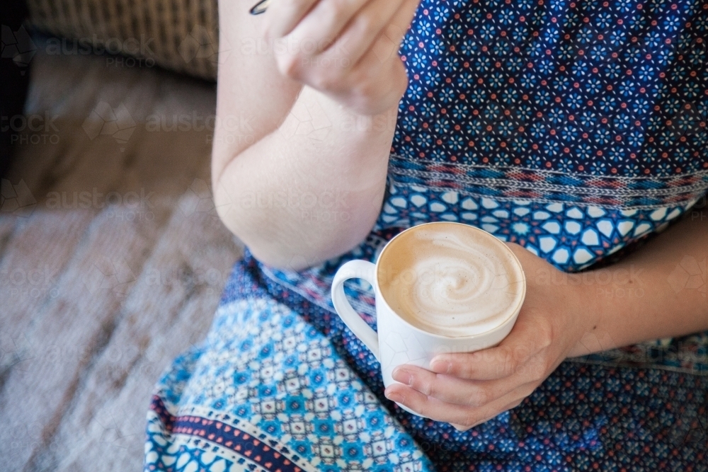 Image of Teen girl holding a coffee in her hand - Austockphoto