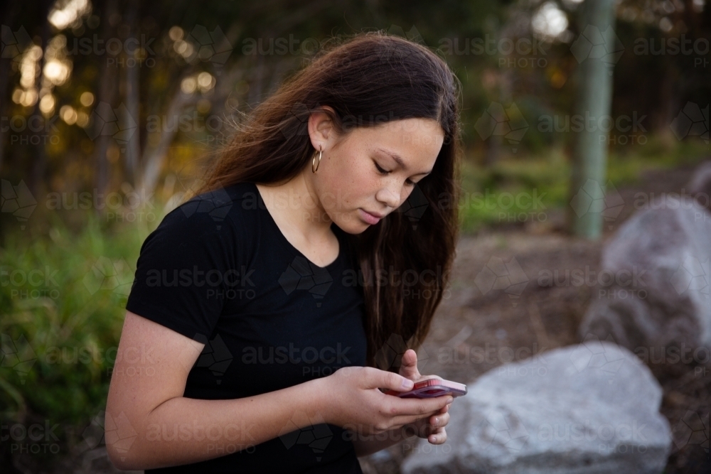 Image Of Teen Girl Scrolling On Her Phone Austockphoto