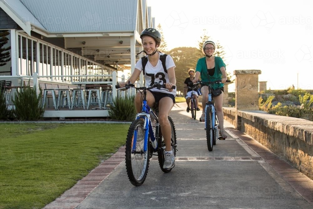 Image of Teen girls riding bikes on dual use path at Busselton ...