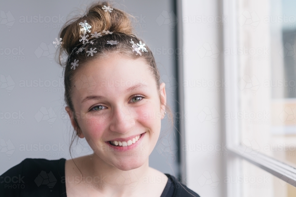 Image of teen with hair bun and snowflakes - Austockphoto