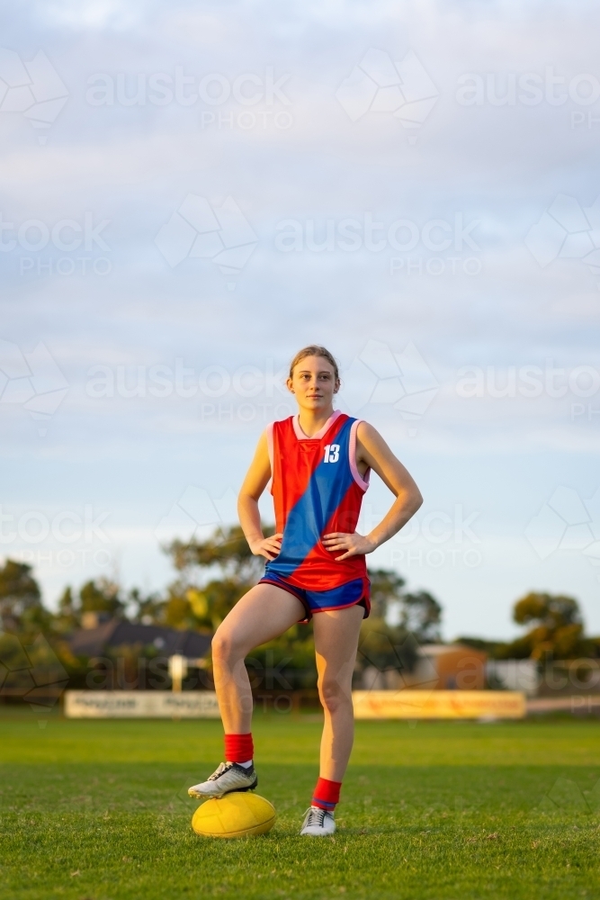 Image of teenage aussie rules footballer standing with hands on hips ...