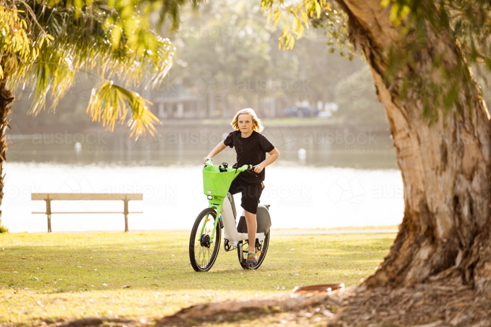 Image of Teenage boy riding public motorised bike in Gold Coast park ...
