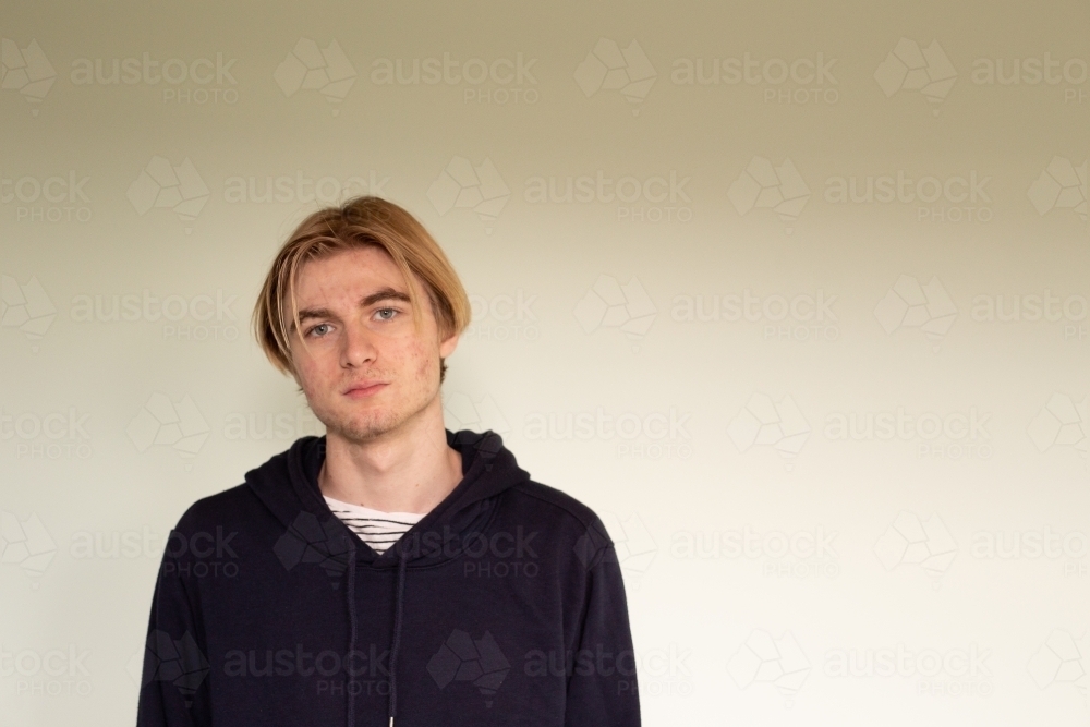 Image of Teenage boy staring at camera - Austockphoto