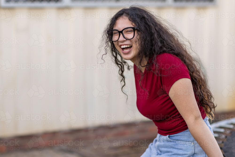Image of teenage girl wearing glasses laughing with mouth open ...