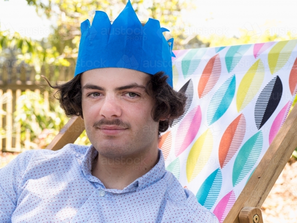 Image of Teenager waers a Christmas cracker hat - Austockphoto