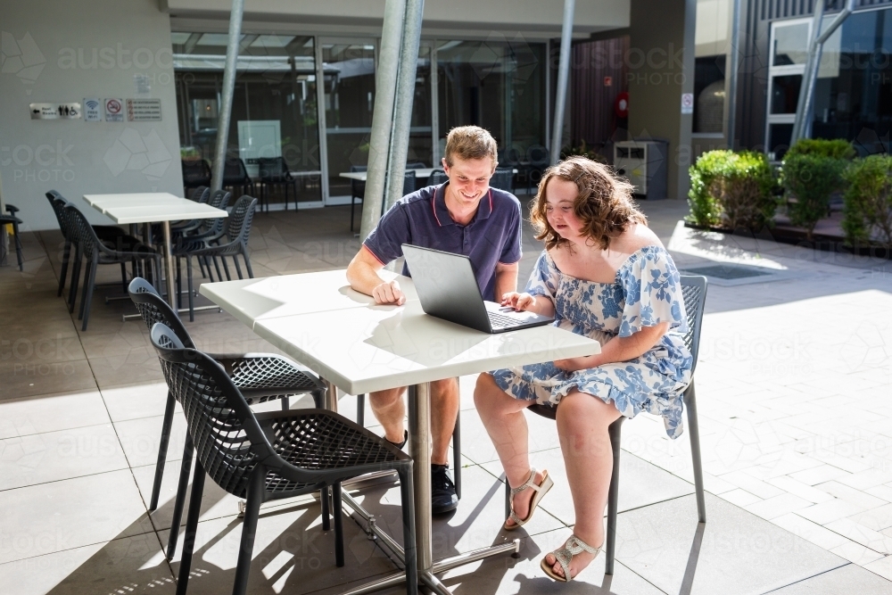 Image of Teenager who had down syndrome using laptop and talking with ...