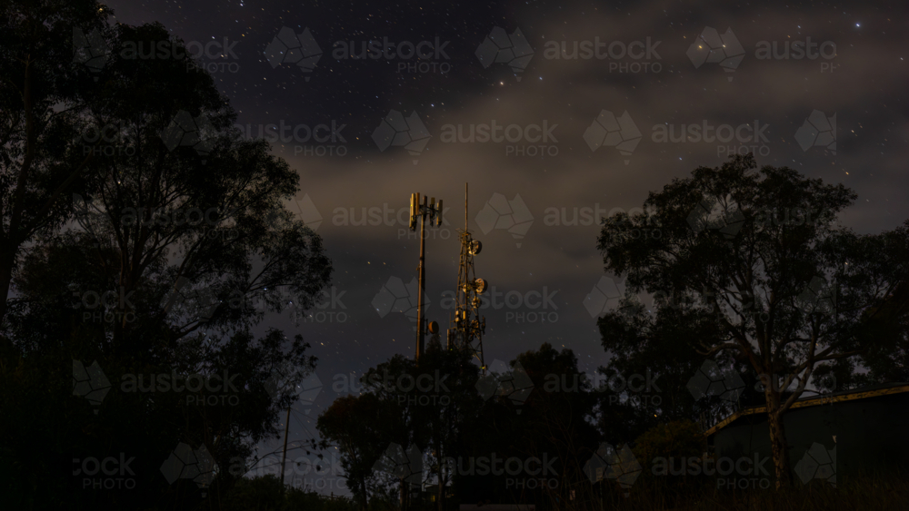 Image of Telecommunications tower illuminated at night with starry ...