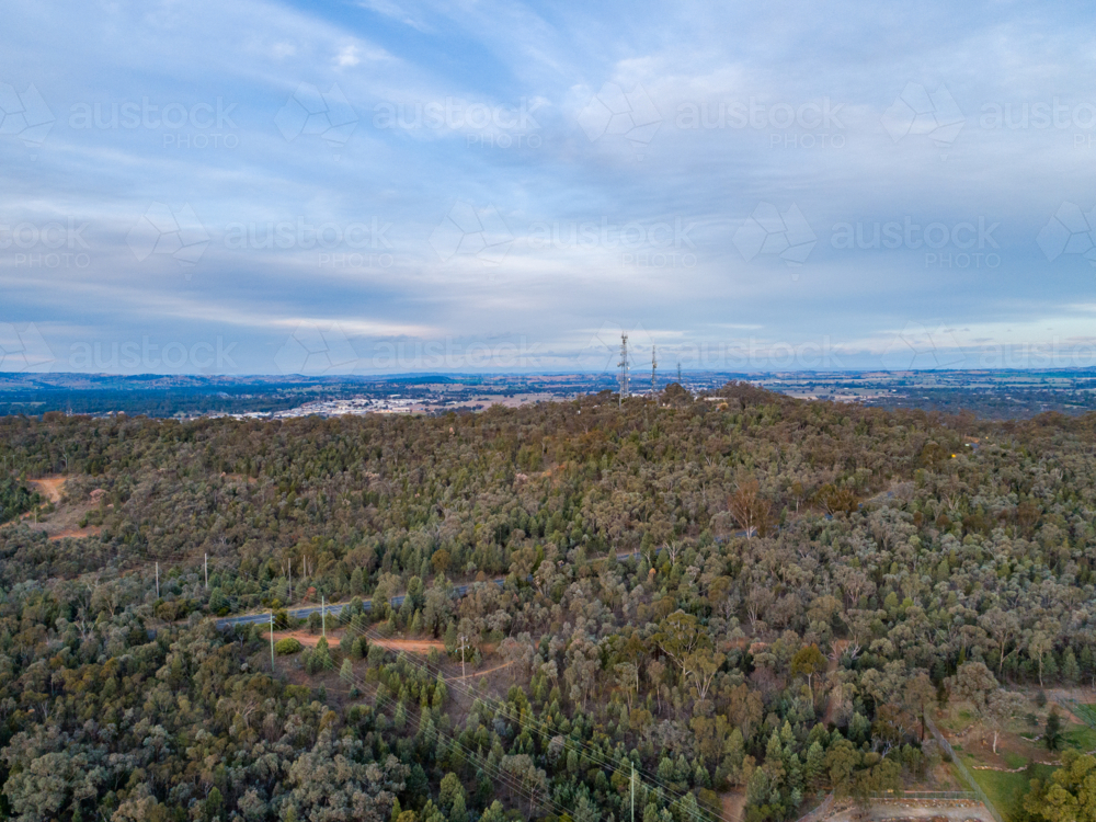 Image of Telecommunications tower on tree covered hilltop outside rural ...