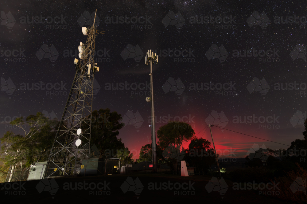 Image of Telecommunications towers in rural area illuminated at night ...