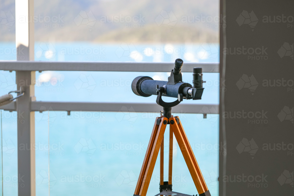 Image of Telescope pointing towards seaside view from balcony in The ...